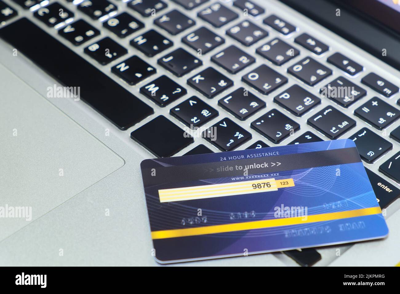 Blue credit card on locked mode put on keyboard of modern laptop ...