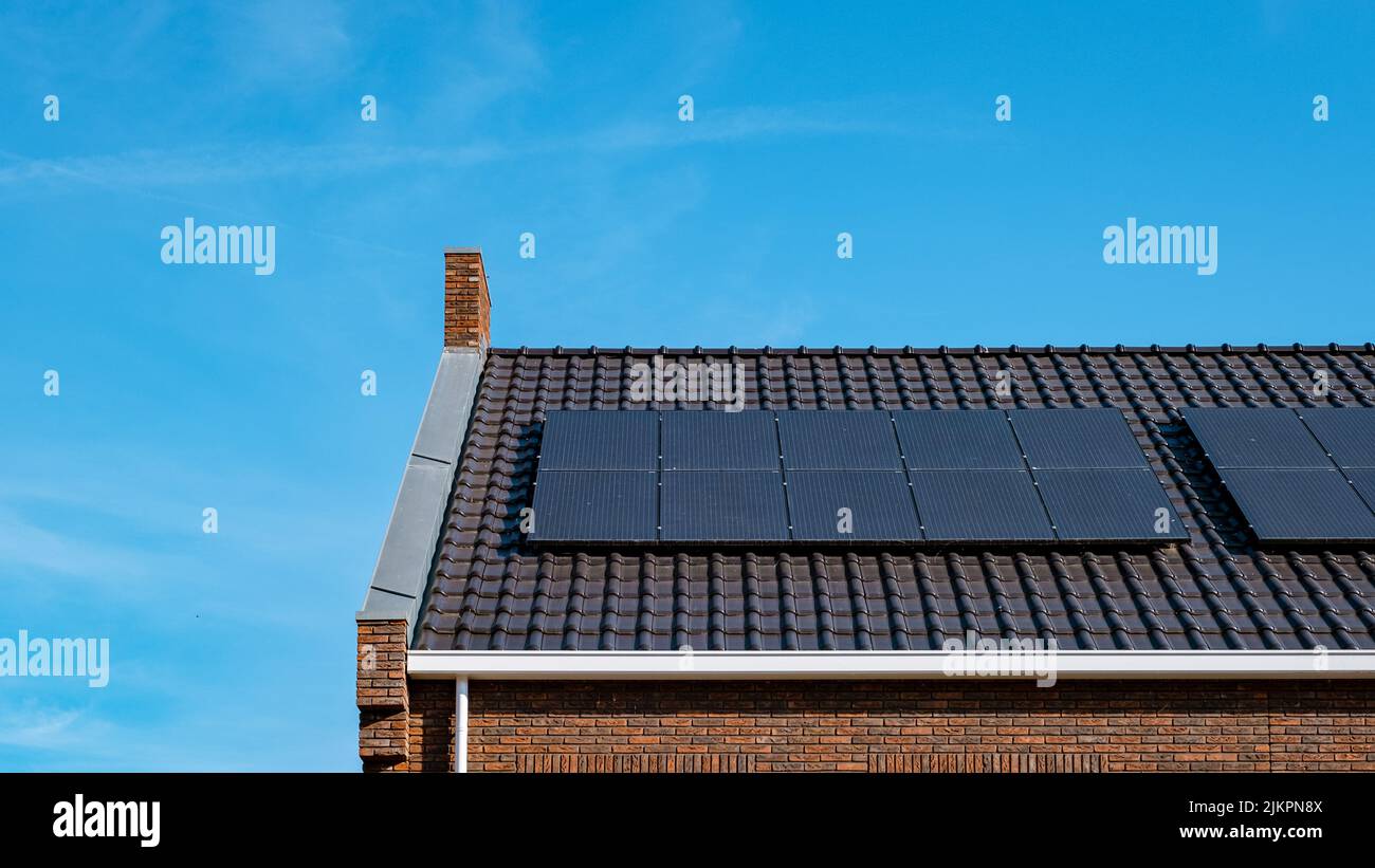 Newly build houses with solar panels attached on the roof against a ...