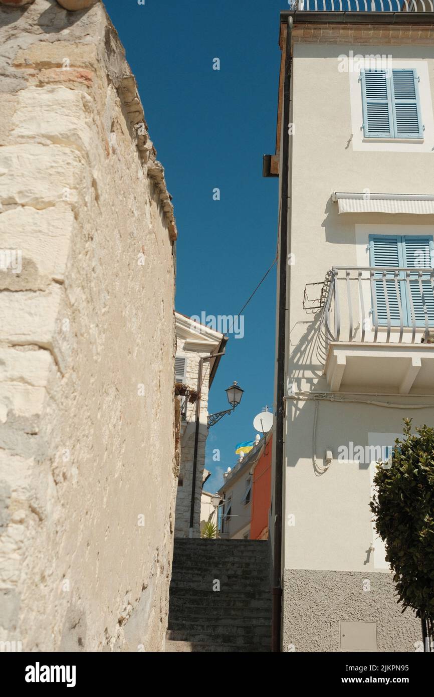 A vertical view of narrow steps between medieval stone buildings in ...