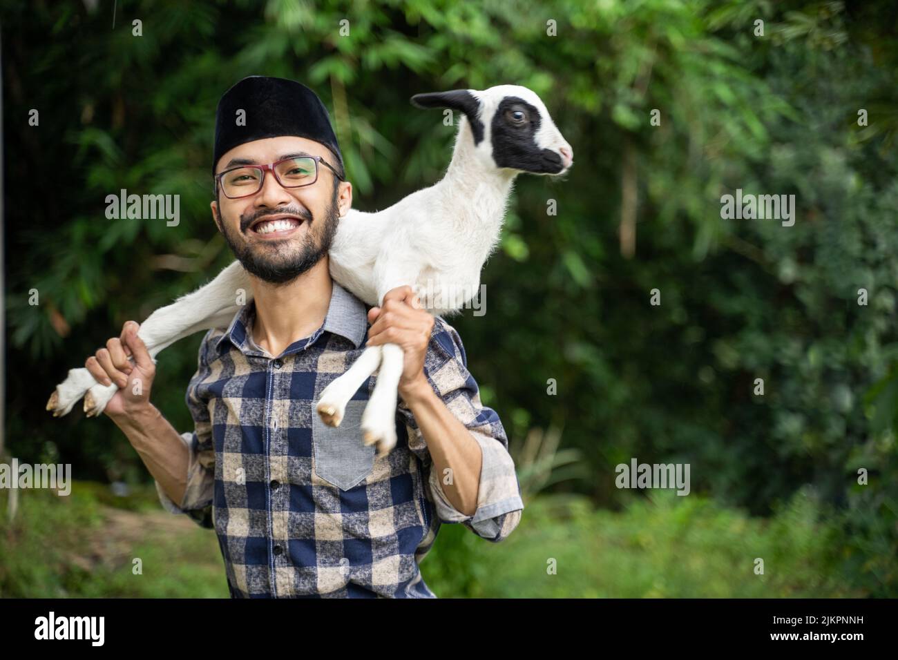 man farmer and seller of goat and cow checking his goat Stock Photo - Alamy
