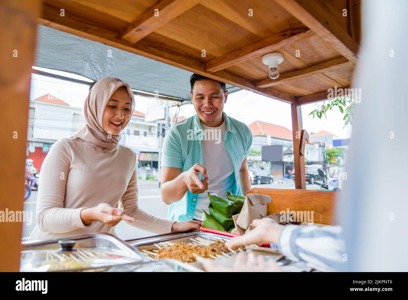 muslim couple ordering food to break fasting in ramadan Stock Photo - Alamy