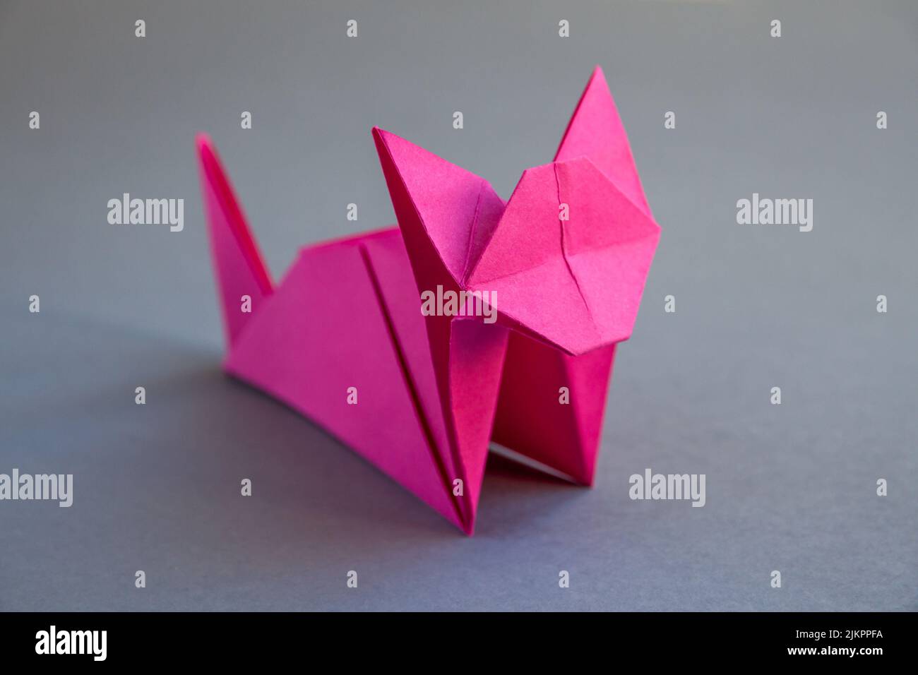 Pink paper cat origami isolated on a blank grey background Stock Photo ...
