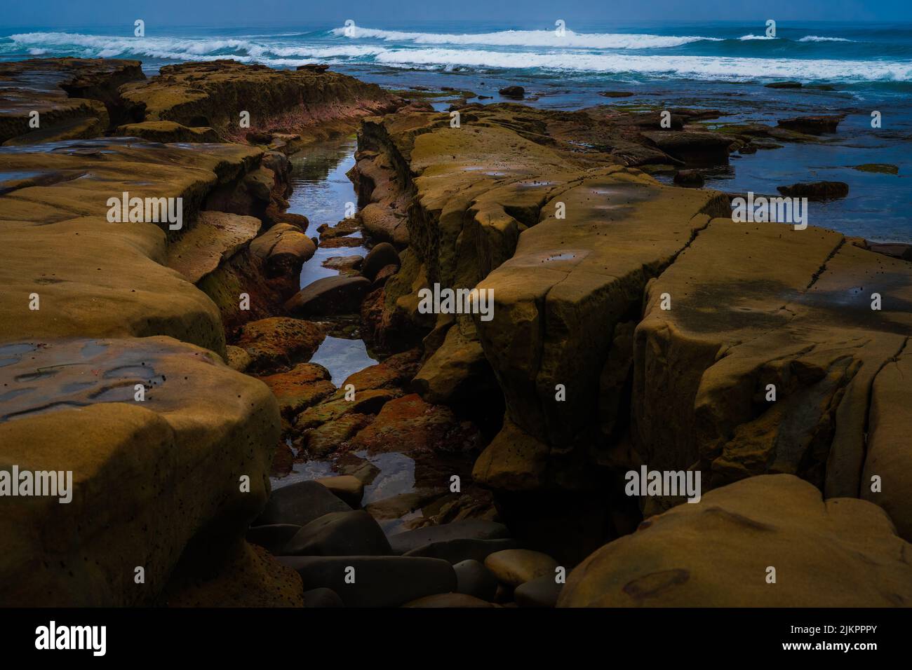 THE ROCKY SHORELINe IN LA JOLLA CALIFORNIA WITH WATER MOVING THROUGH ...