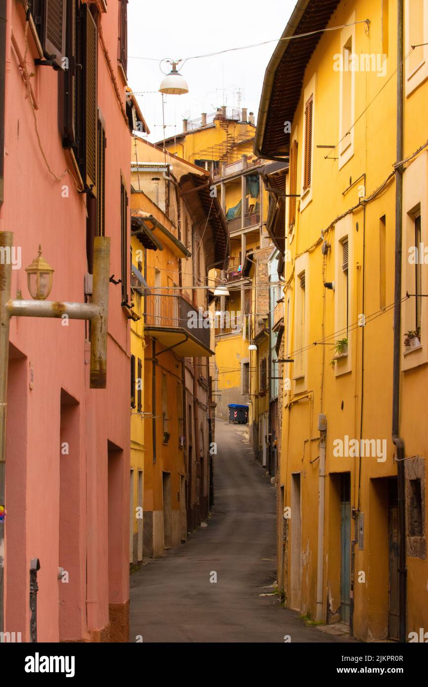 A vertical shot of narrow street between buildings Stock Photo - Alamy