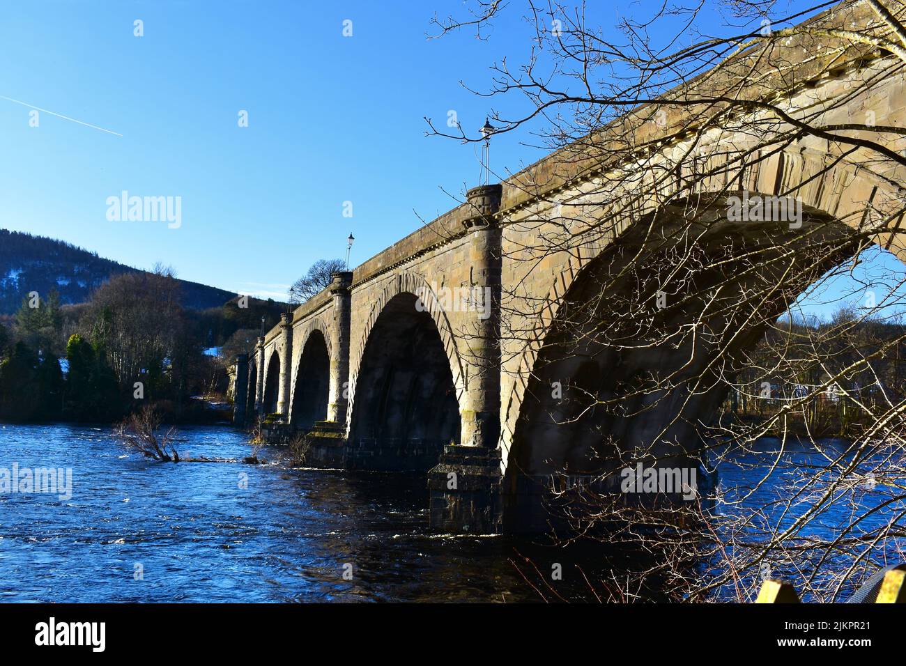 A winter view of the old stone bridge over the river Tay, designed by ...
