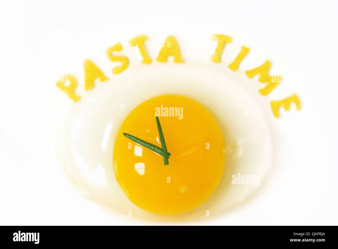 Raw egg in form of a clock with noodle letters for pasta time Stock ...