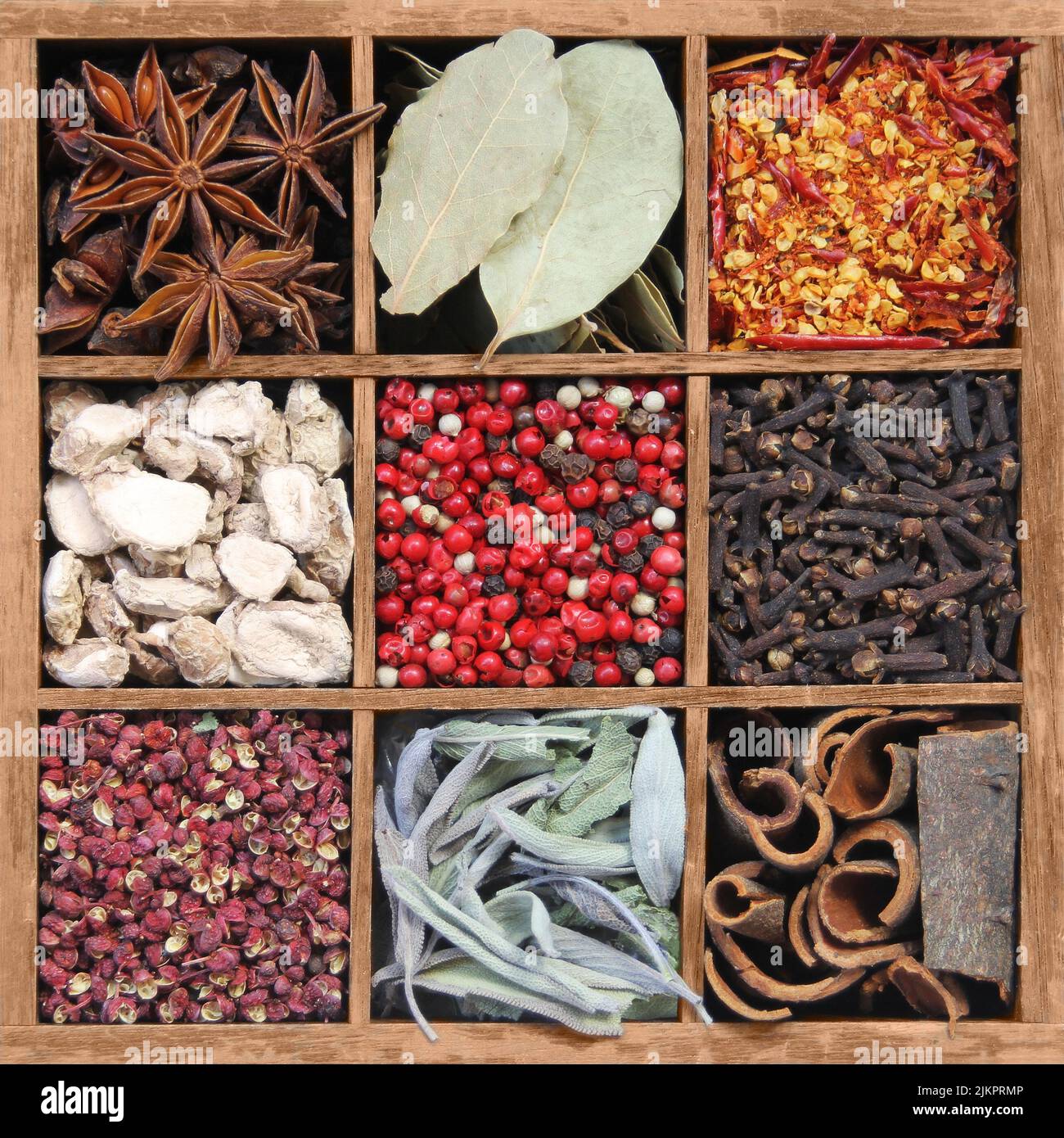 Spices in wooden box (from top left: star anise, bay leaf, chili, dried ...