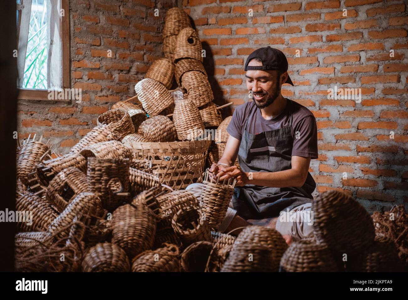 Water hyacinth craftsman man making baskets in village Stock Photo - Alamy