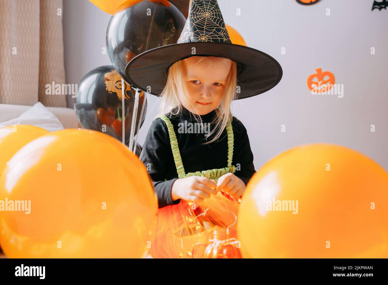 Children's Halloween - a girl in a witch hat and a carnival costume ...