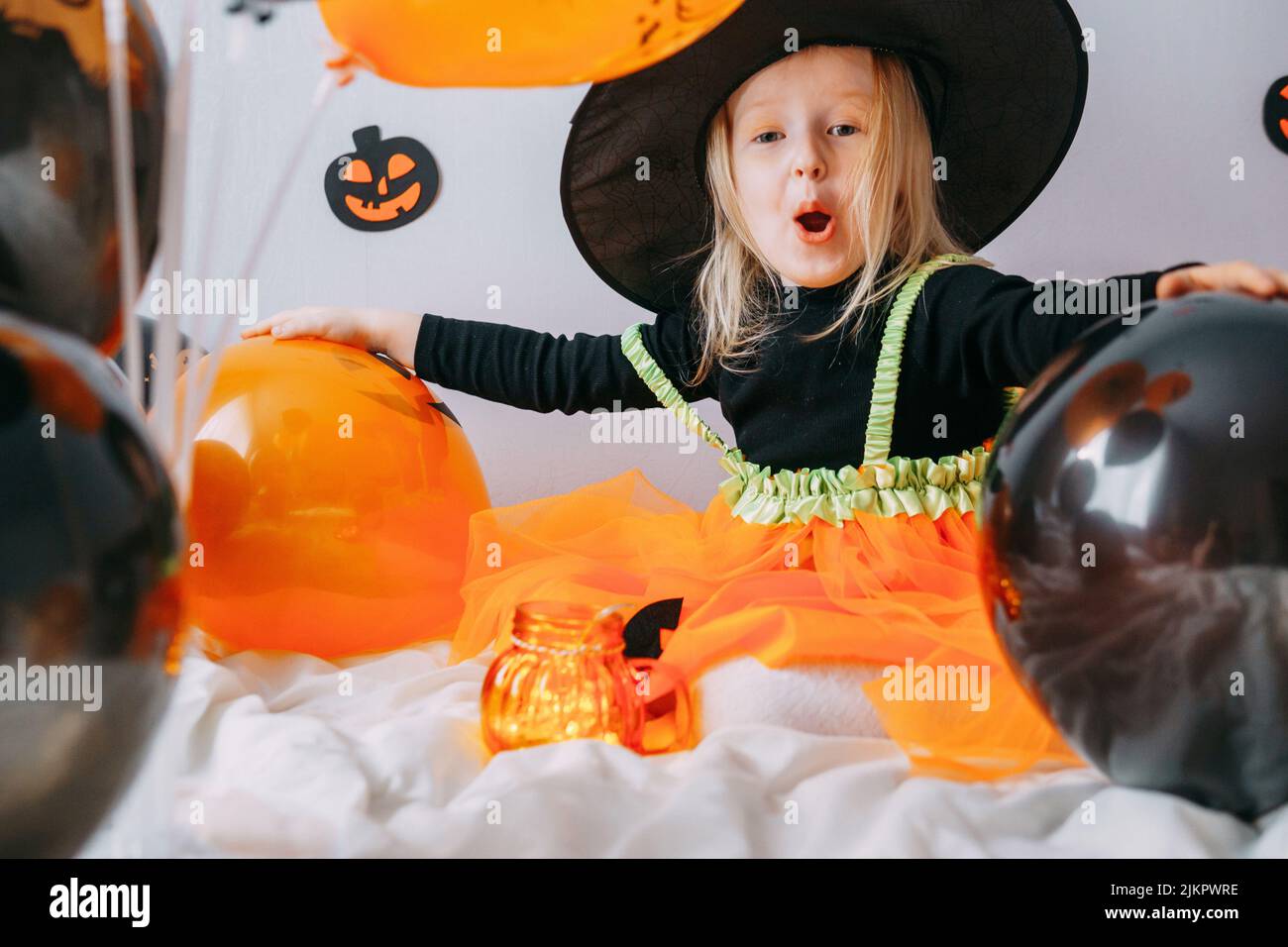 Children's Halloween - a girl in a witch hat and a carnival costume ...