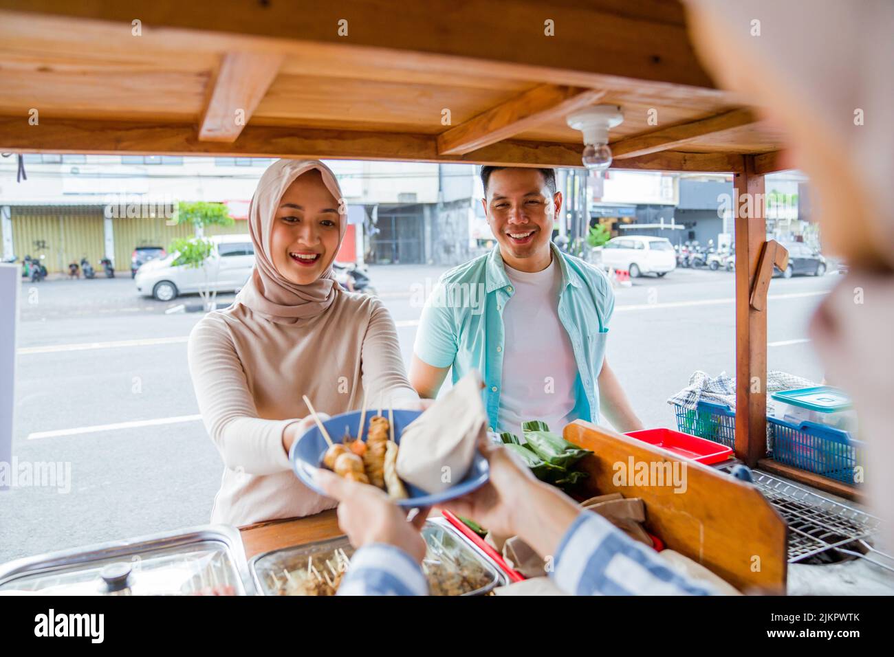 muslim couple ordering food to break fasting in ramadan Stock Photo - Alamy