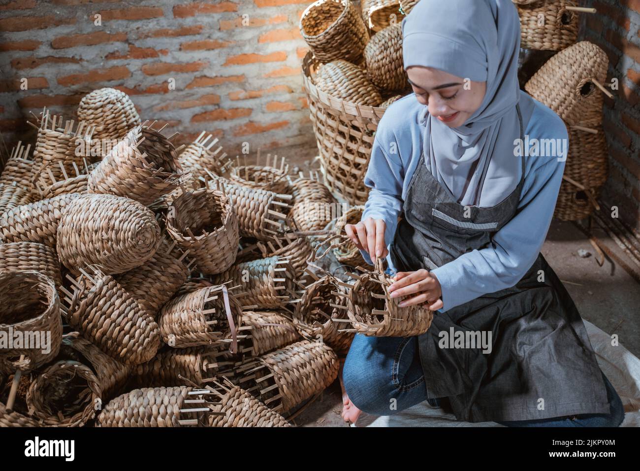 close up of craftswoman in veil weaving water hyacinth crafts Stock ...