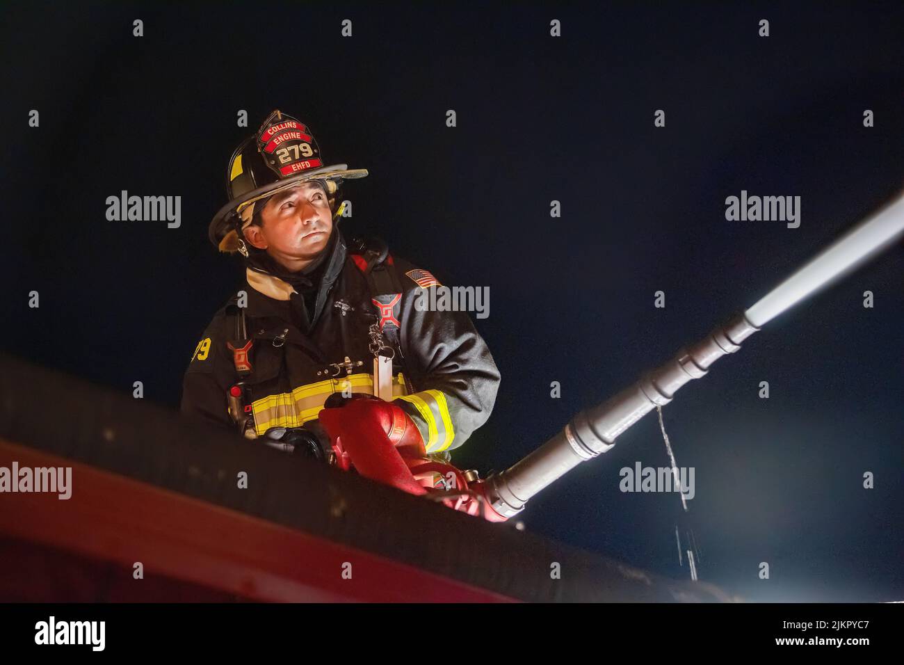 East Hampton firefighter Charlie Collins operates a deck gun atop an ...