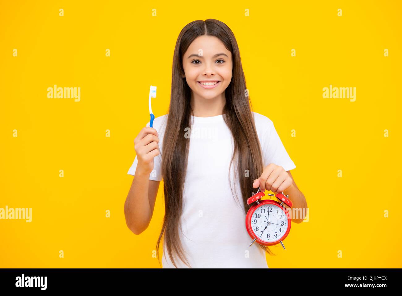 Happy teenager portrait. Girl cleans her teeth with a brush. Time to ...
