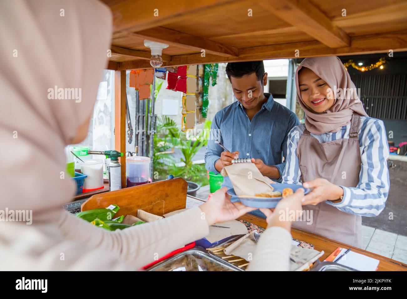 muslim couple ordering food to break fasting in ramadan Stock Photo - Alamy