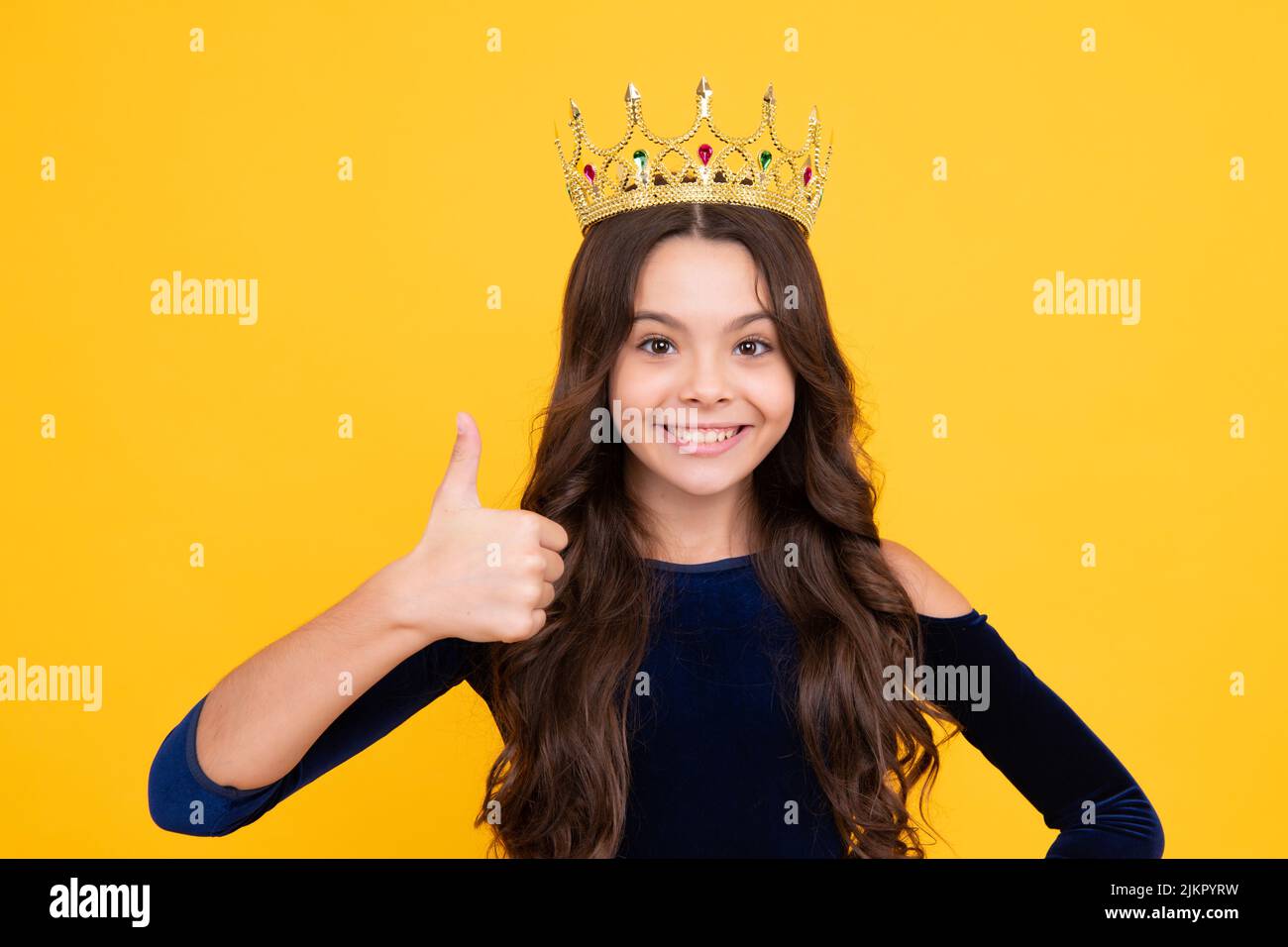 Girls birthday party, funny kid in crown. Imagine herself a queen ...