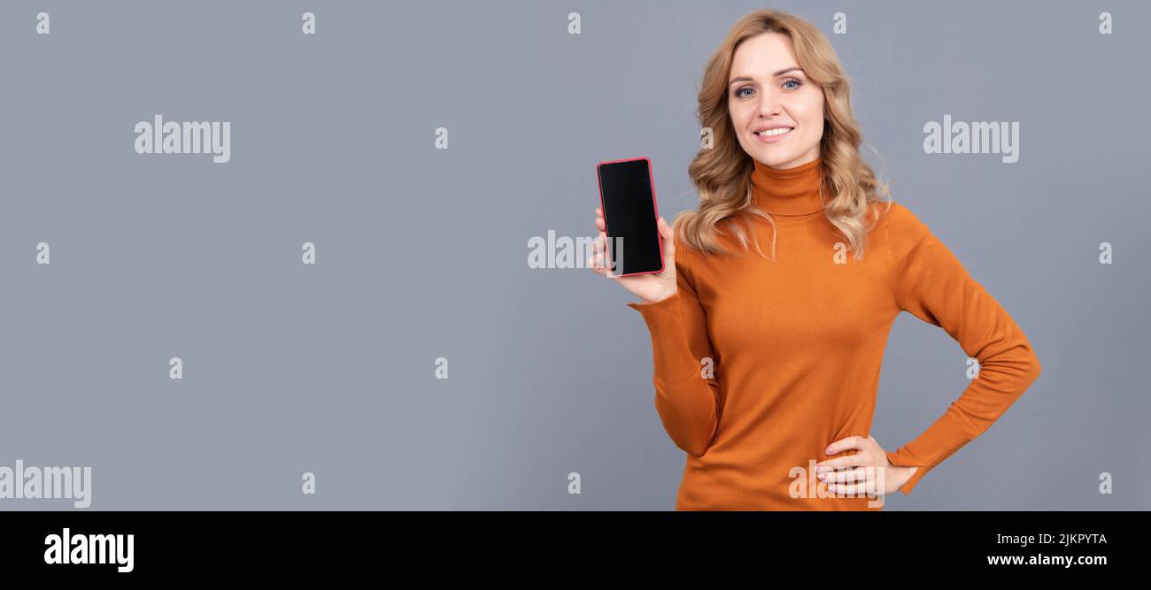 Happy woman hold modern smart phone grey background, mobile device ...