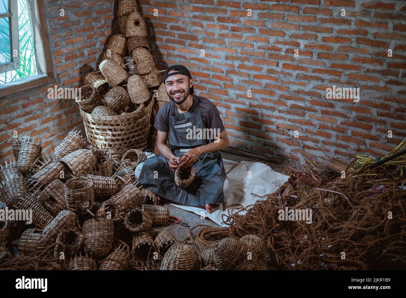 Top view of a water hyacinth craftsman sitting and smiling Stock Photo ...