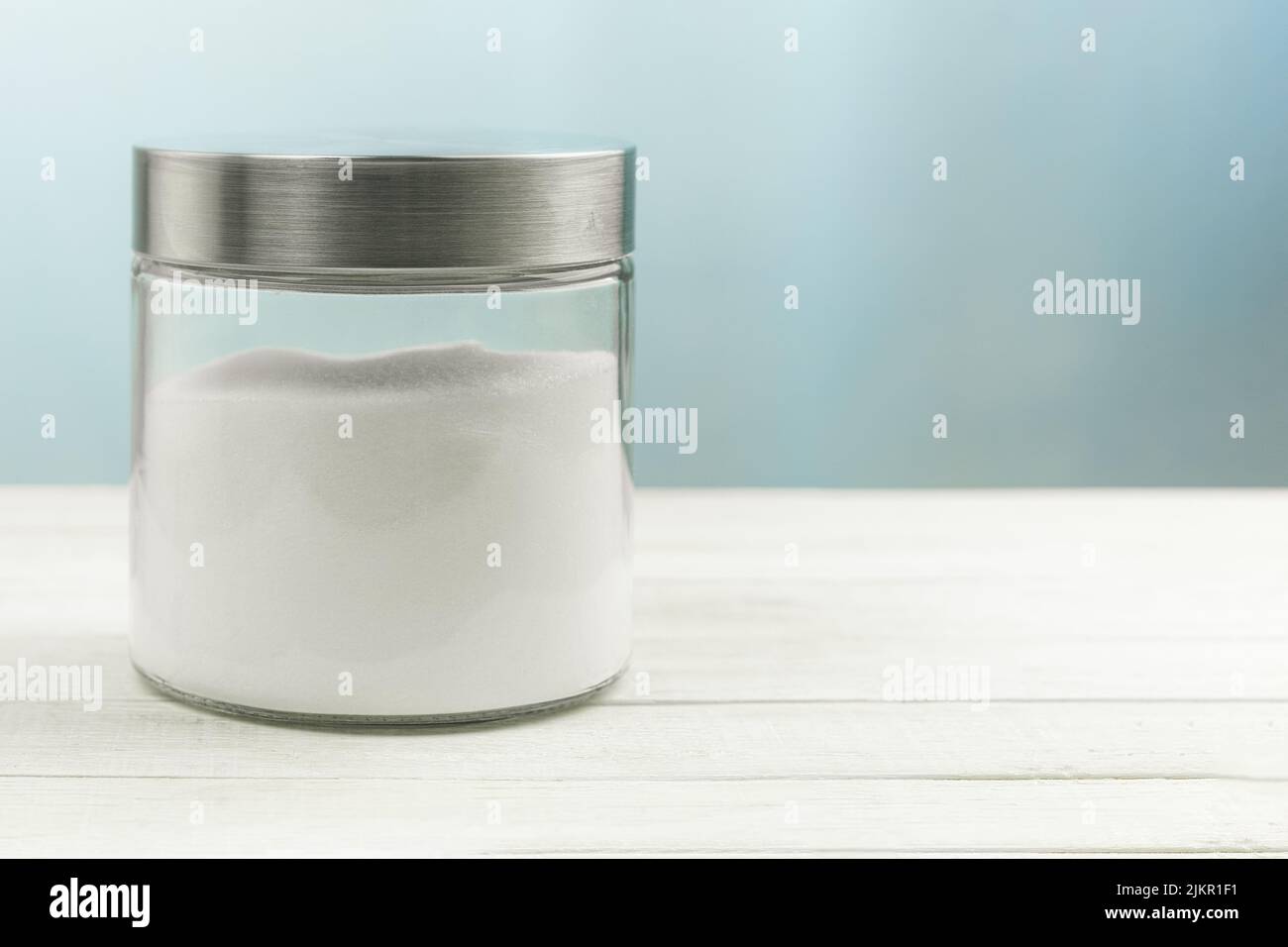 Fine kitchen salt in a glass jar. Food, cooking and unhealthy eating ...