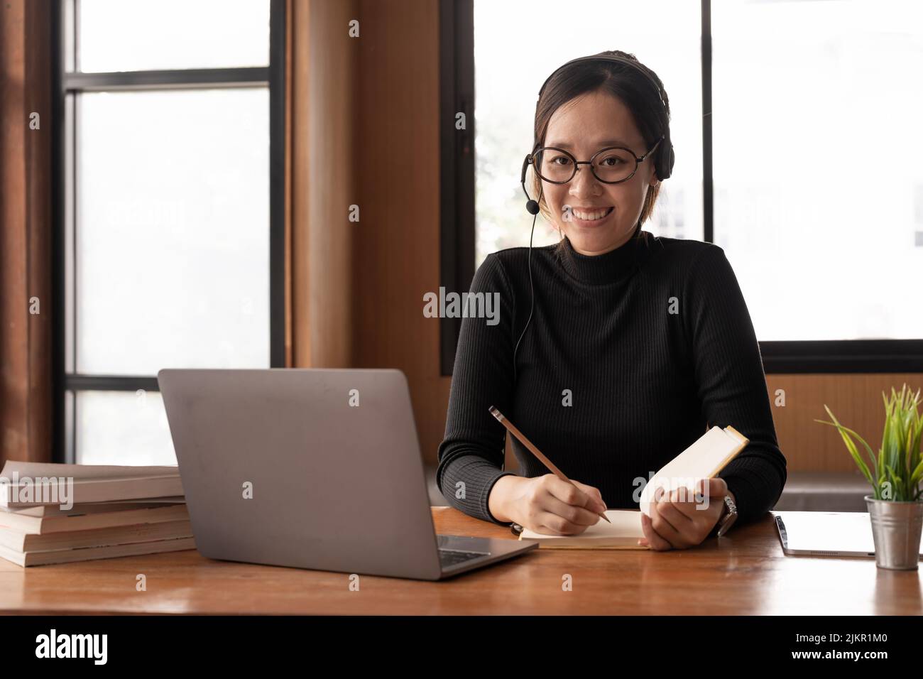 Attractive female student learning language, watching online webinar ...
