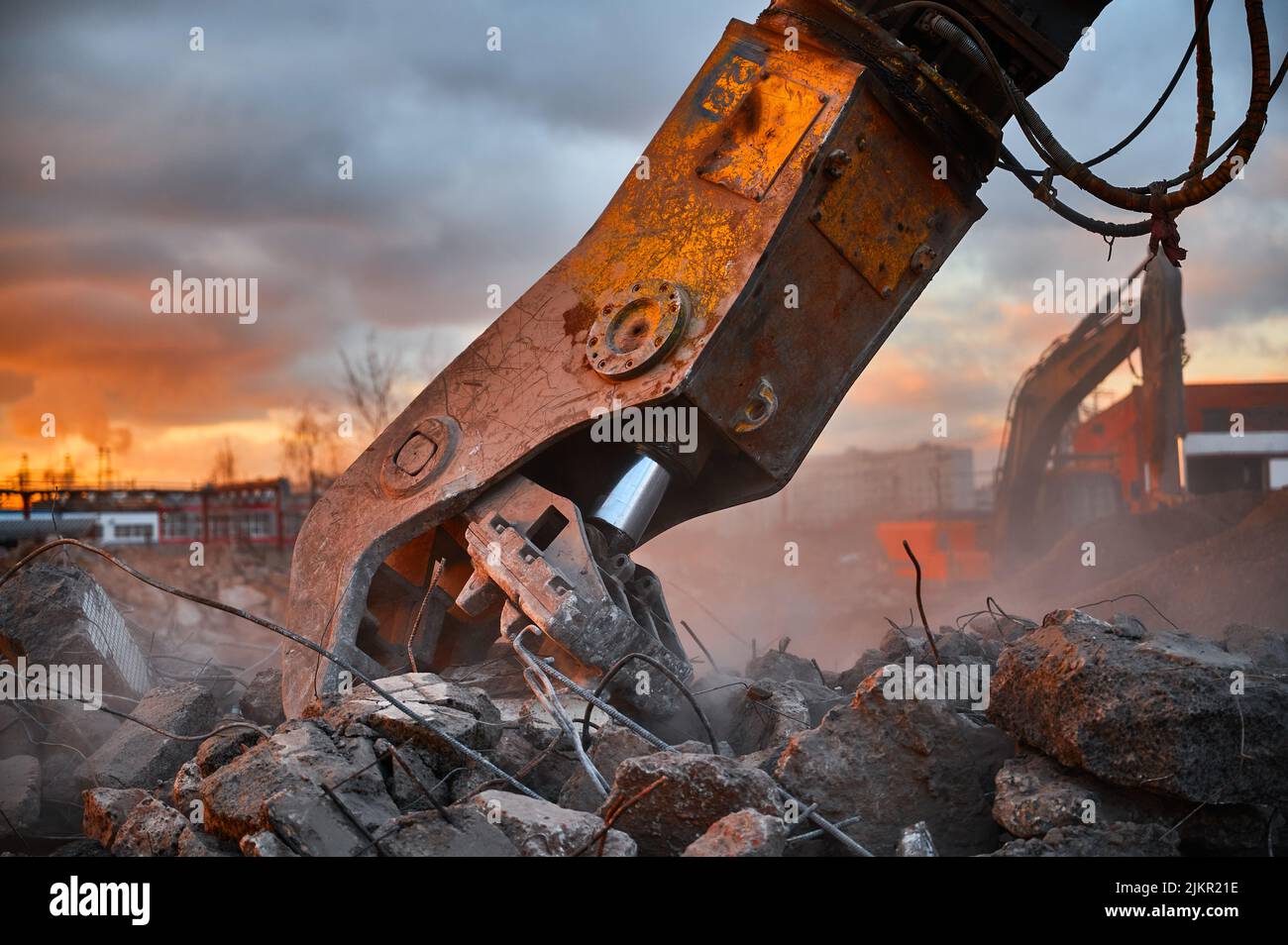 Modern crusher on excavator rigging dismantles concrete beam Stock ...