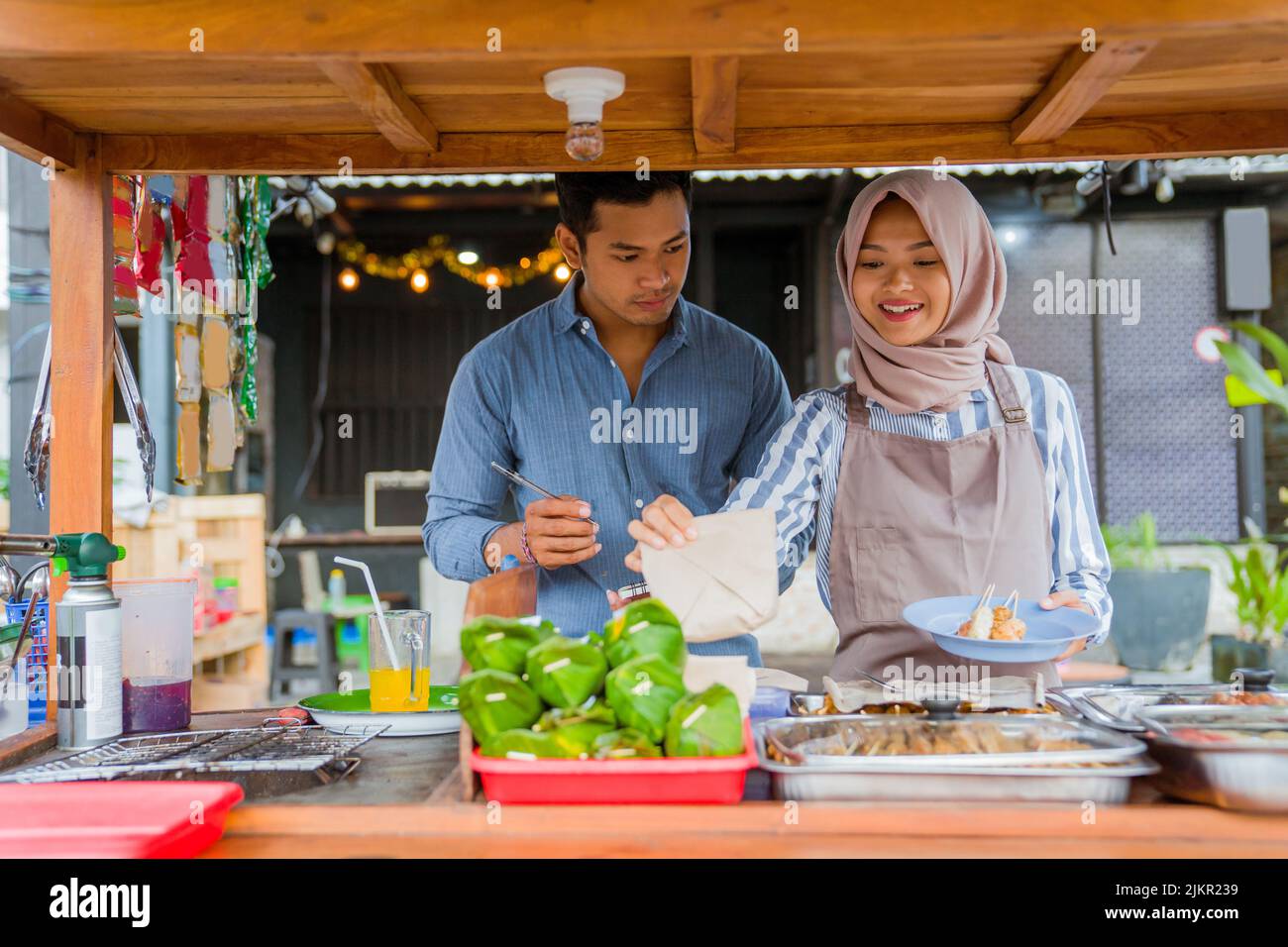 customer picking an order in traditional food market stall Stock Photo ...