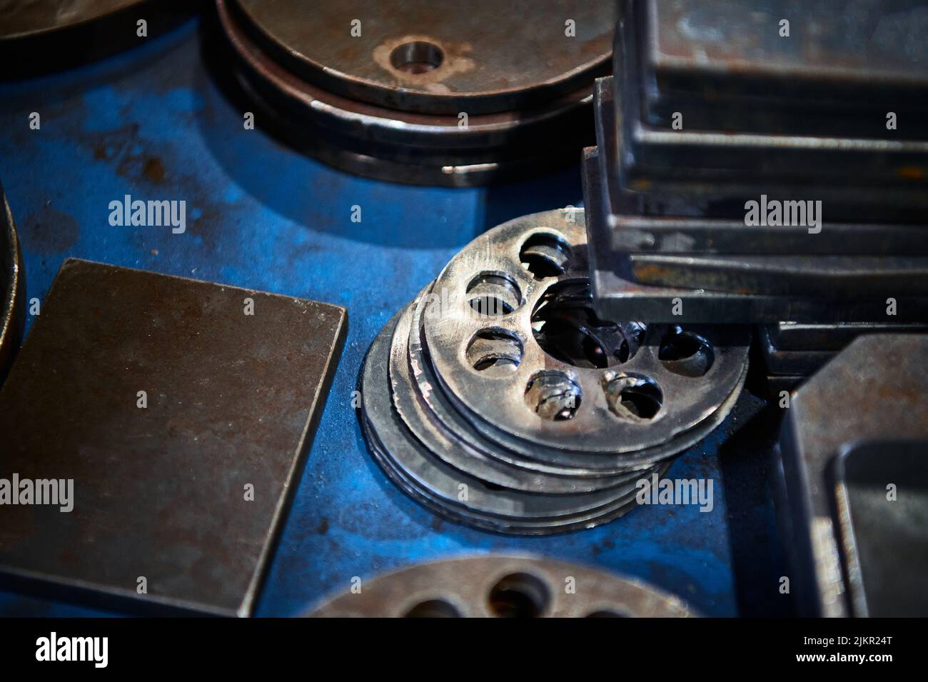 Piles of different workpieces made of metal material sheet Stock Photo ...