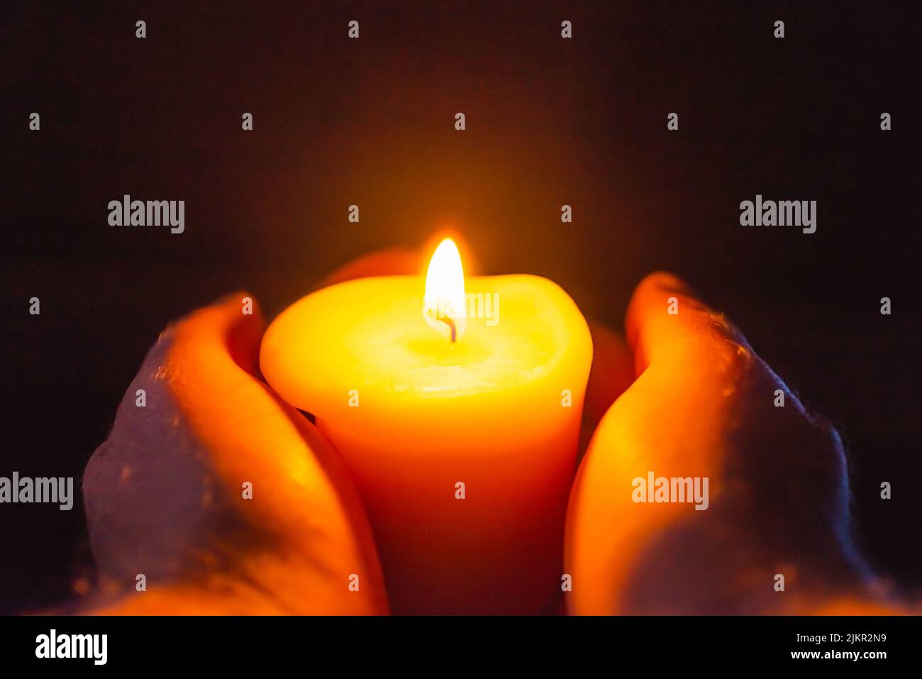 Burning candle in a mans hand religion concept.Candle in hands on a ...
