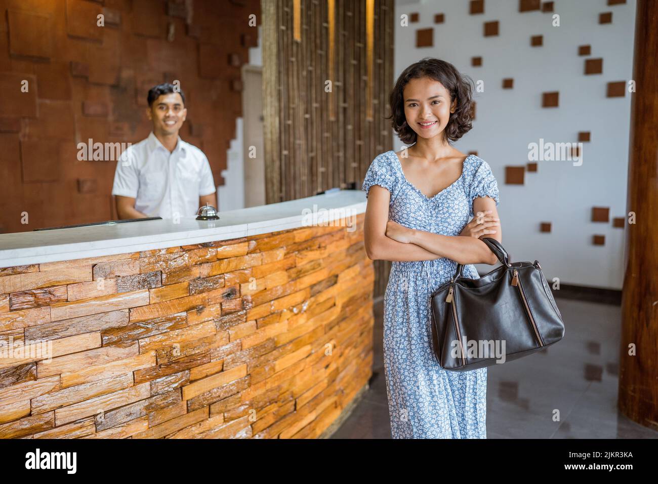Female guest standing smiling against the background of the ...