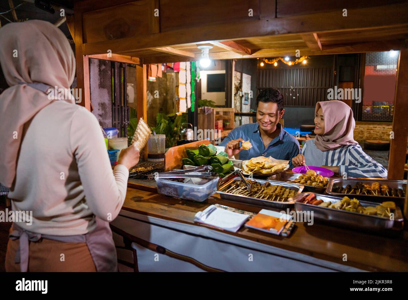 muslim couple ordering food to break fasting in ramadan Stock Photo - Alamy