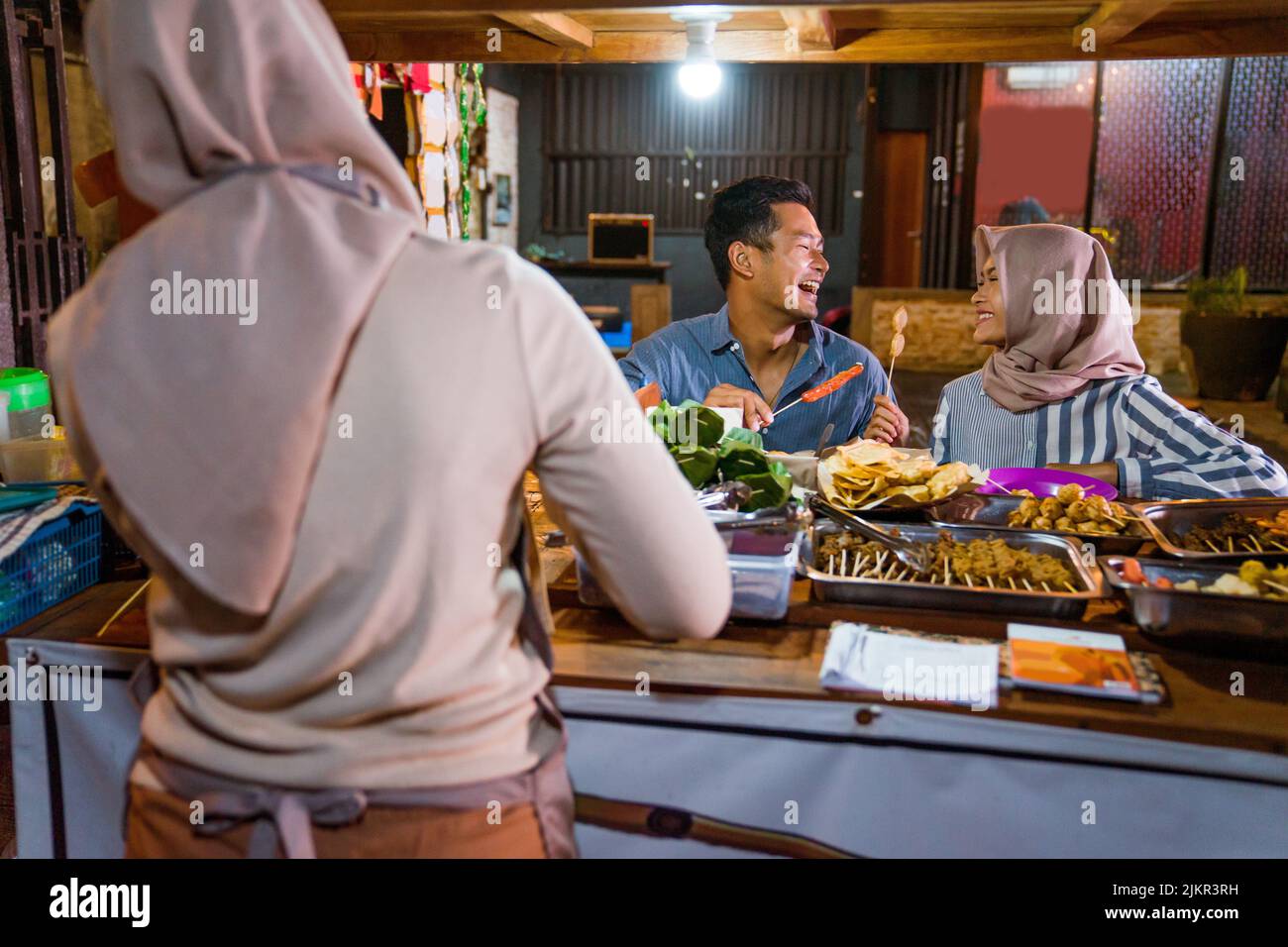 muslim couple ordering food to break fasting in ramadan Stock Photo - Alamy