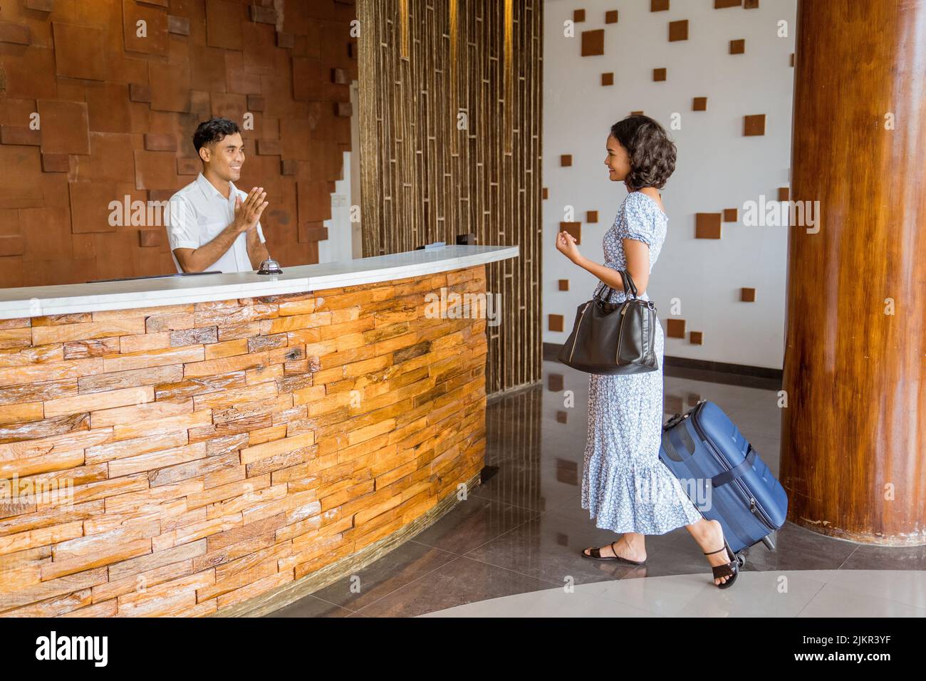 Female guests come with suitcases to the hotel reception Stock Photo ...
