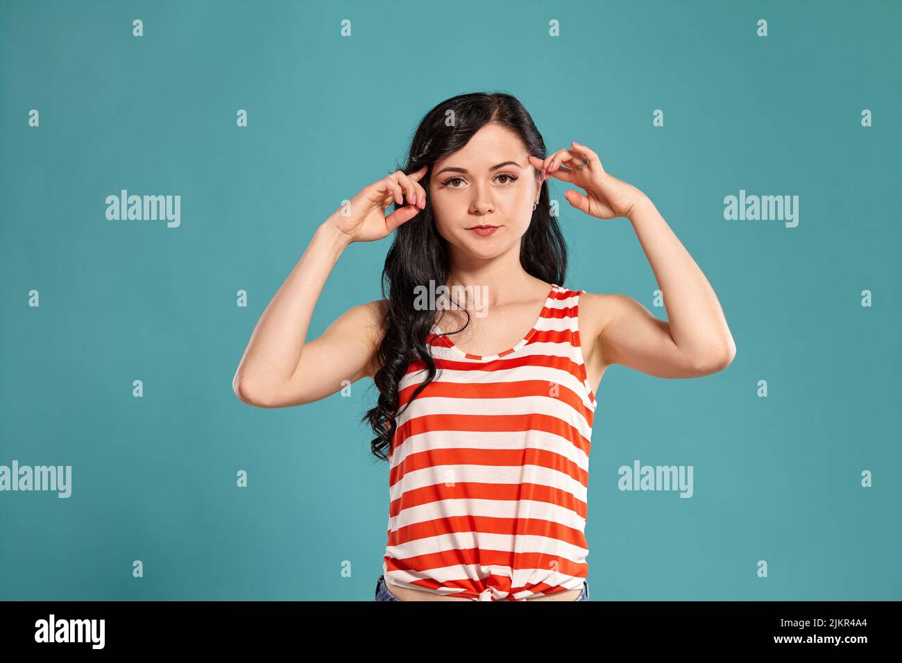 Studio photo of a gorgeous girl teenager posing over a blue background ...