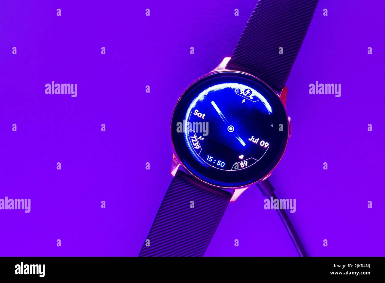 Smart watch on wireless charging with on-screen.Purple,veri peri neon ...