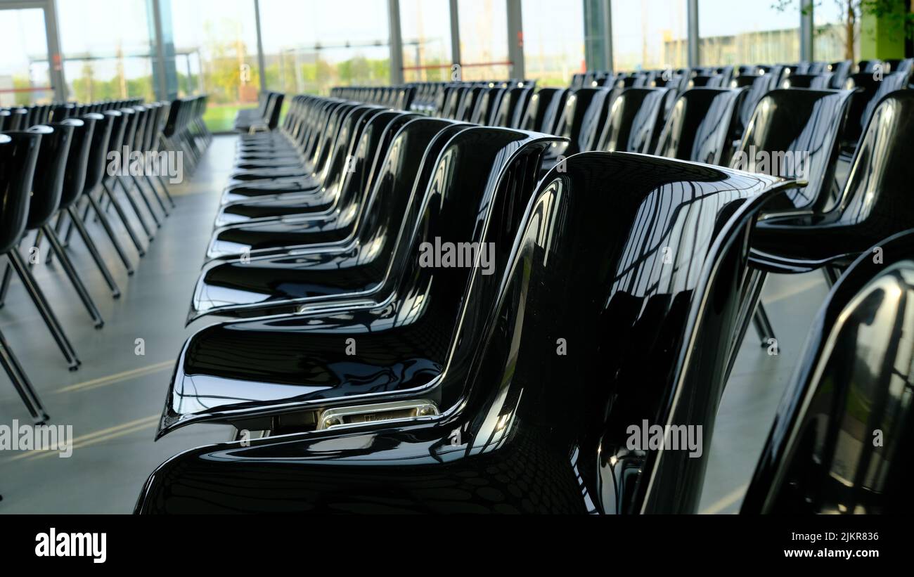 rows of empty black chairs in the great room Stock Photo - Alamy