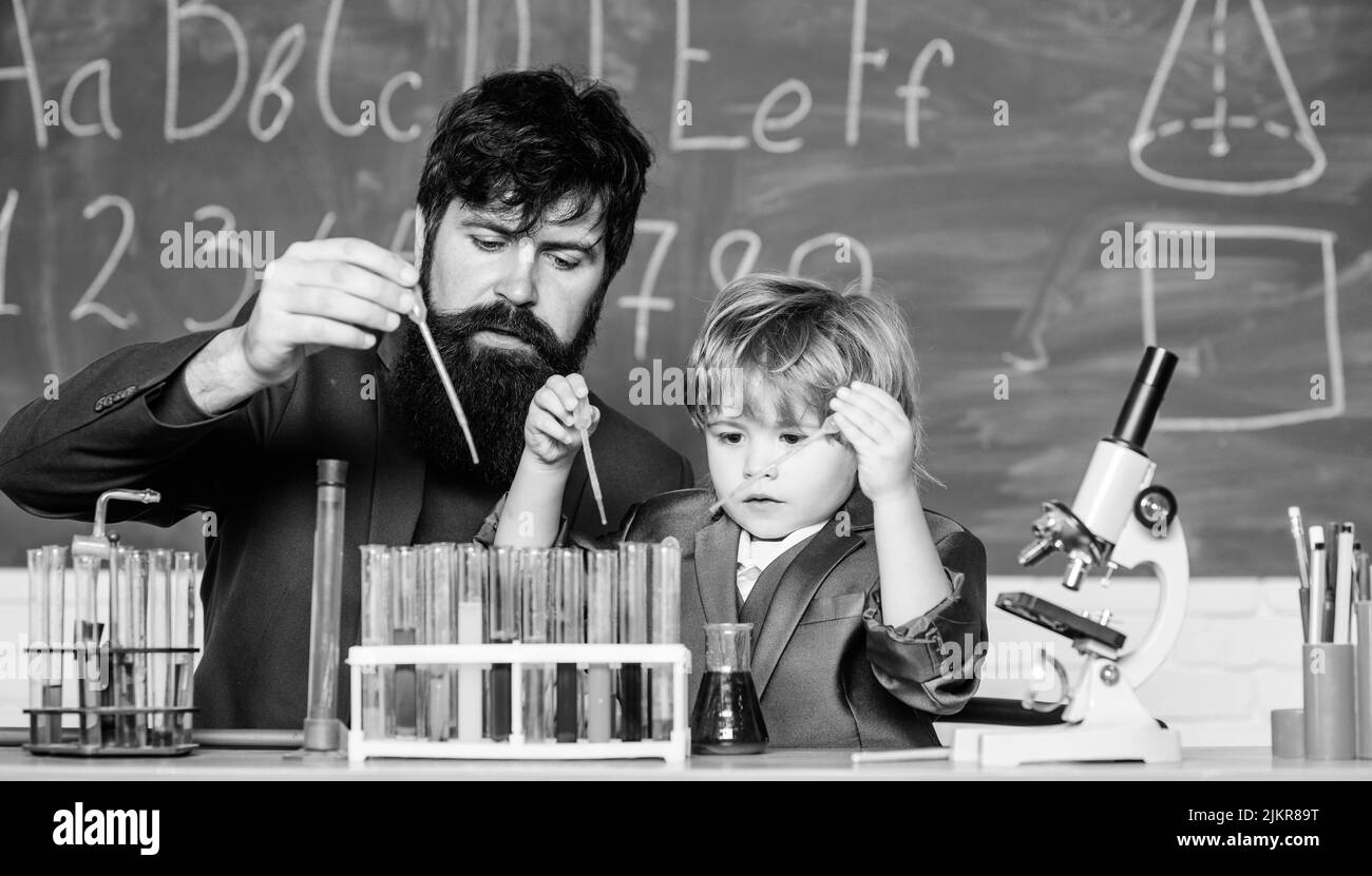 Genius kid. Teacher child test tubes. Chemical experiment. Achieving ...