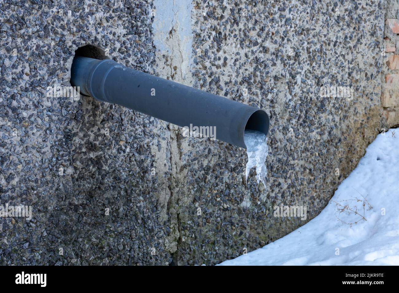A water pipe in a house with a frozen piece of ice Stock Photo - Alamy