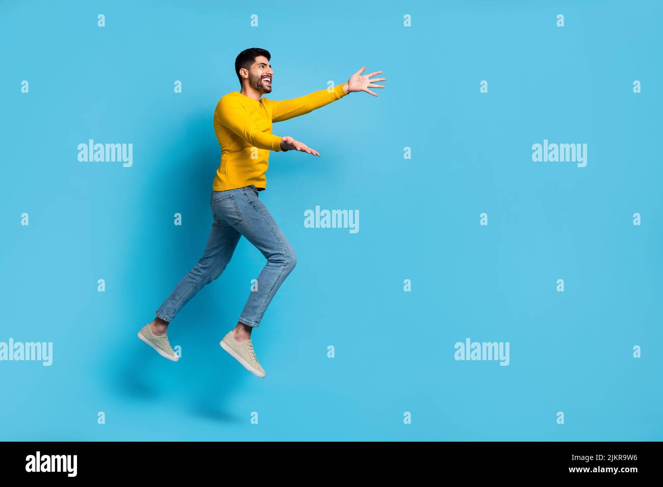 Full body profile photo of energetic satisfied person run jump raise ...