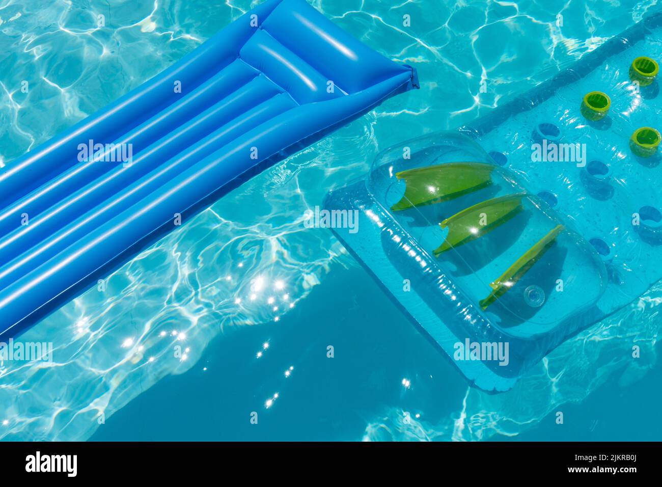 Clear blue summer pool lounger float on a rippled swimming pool Stock ...