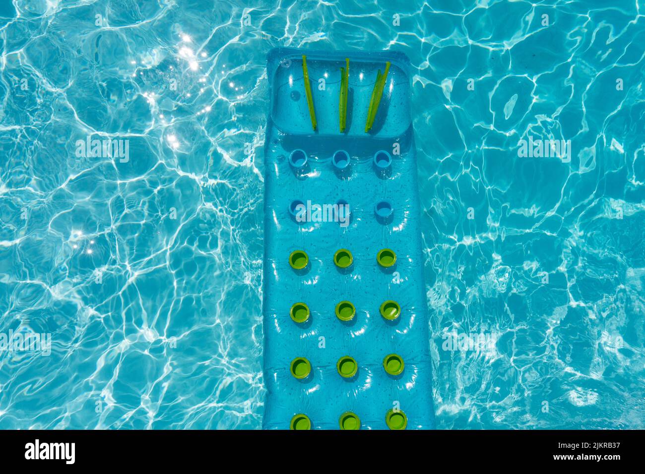 Clear blue summer pool lounger float on a rippled swimming pool Stock ...