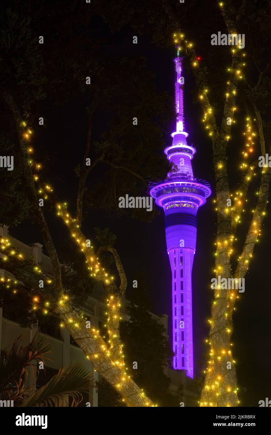 The iconic Sky Tower in Auckland, New Zealand, lit up purple at night ...