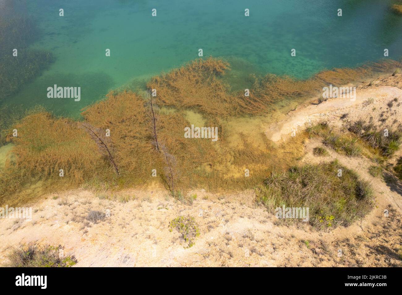 Aerial view over a large blue lake in a forest background Stock Photo ...