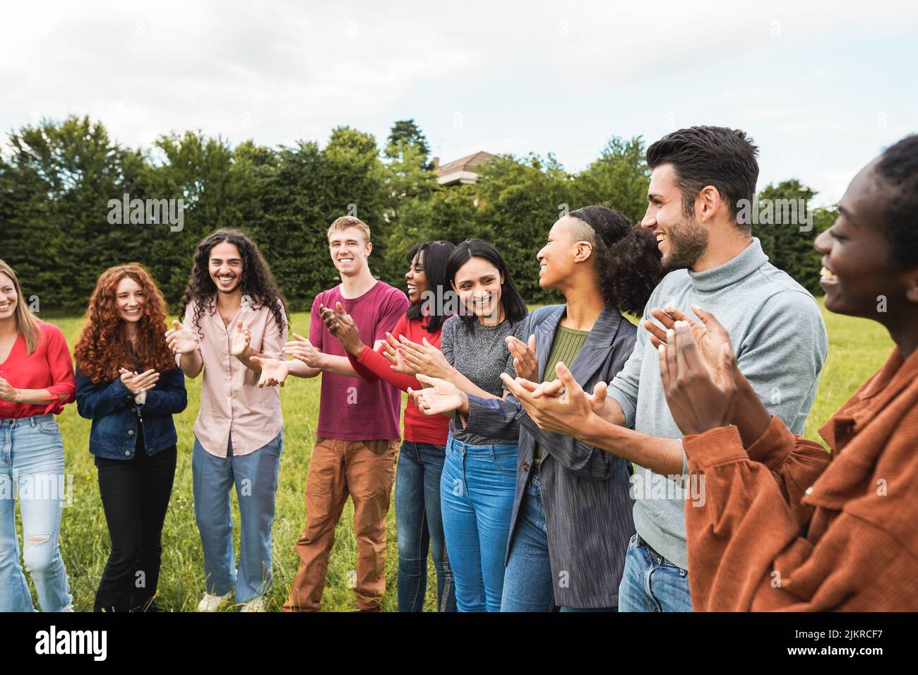 Young diverse people celebrating together outdoor - Focus on african ...