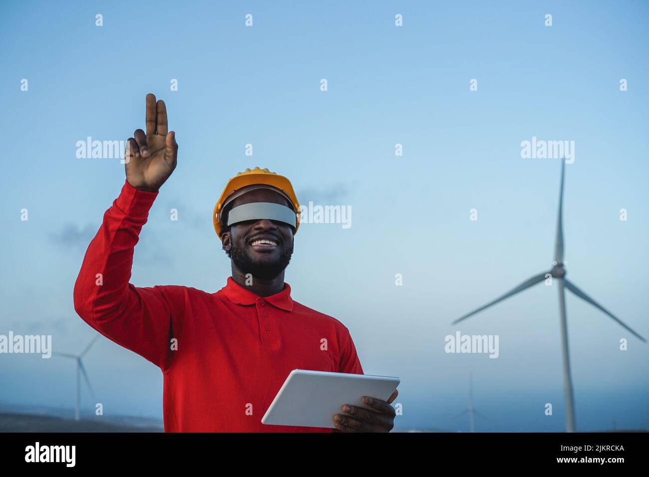 African engineer man using futuristic augmented reality glasses on a ...