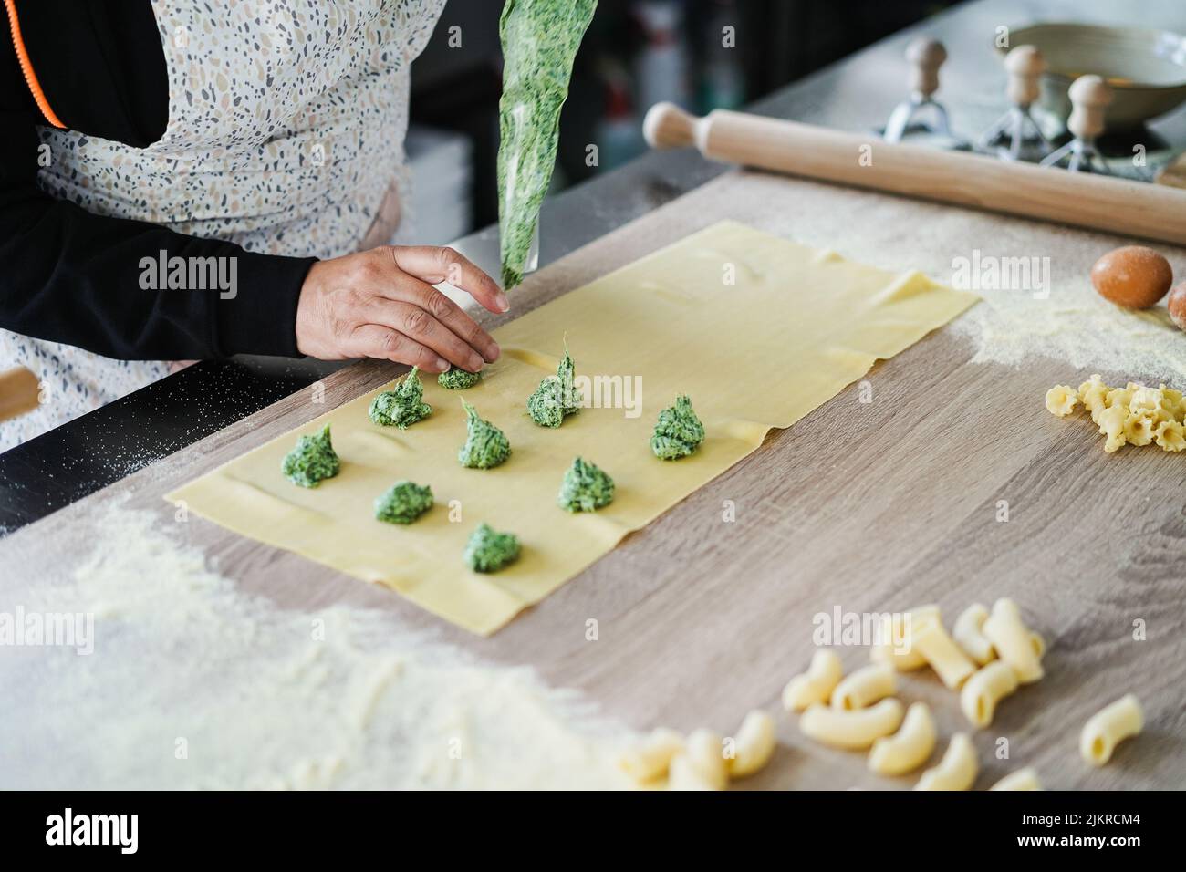 Woman prepare fresh made ravioli inside pasta factory Stock Photo - Alamy