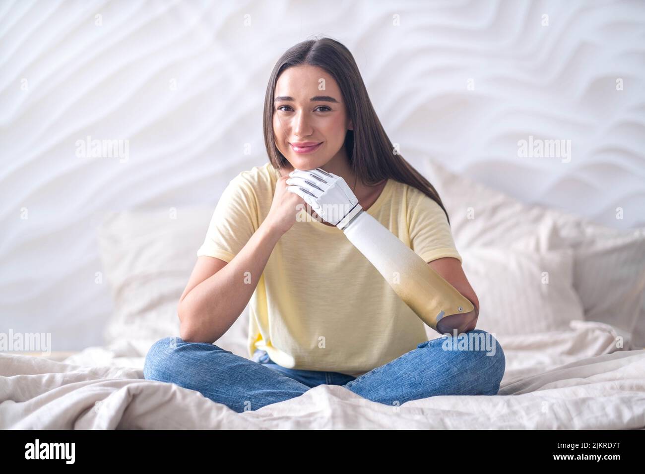 Portrait happy woman with prosthetic arm, girl with disability leads ...