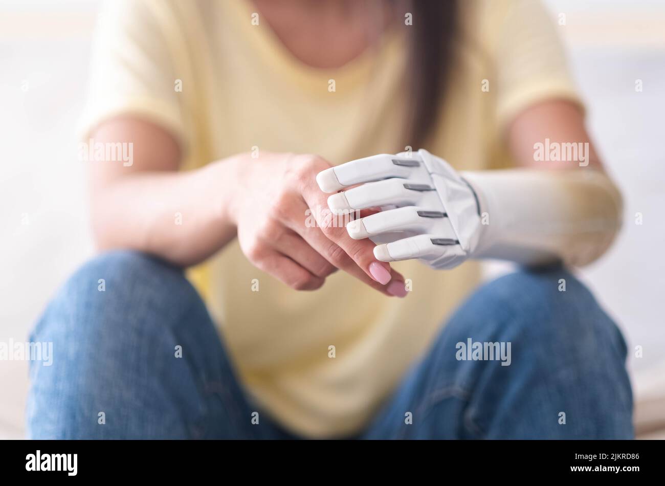 Close up two hands of woman with bionic arm, person lost her arm, girl ...