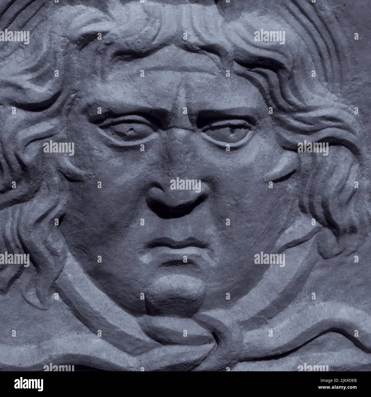Grim Gorgon or Medusa, once believed to ward off evil, glaring from a ...