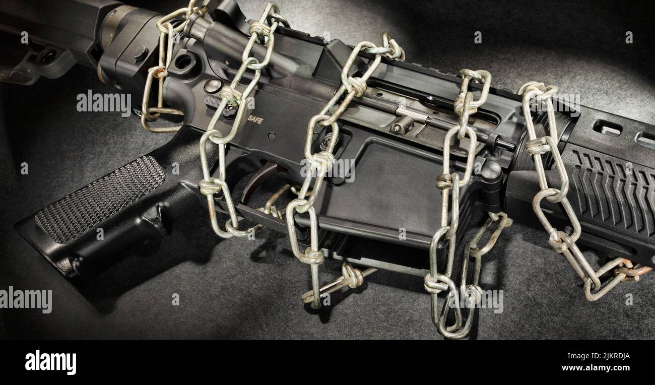 Assault rifle with chain wrapped around to keep it safe Stock Photo - Alamy