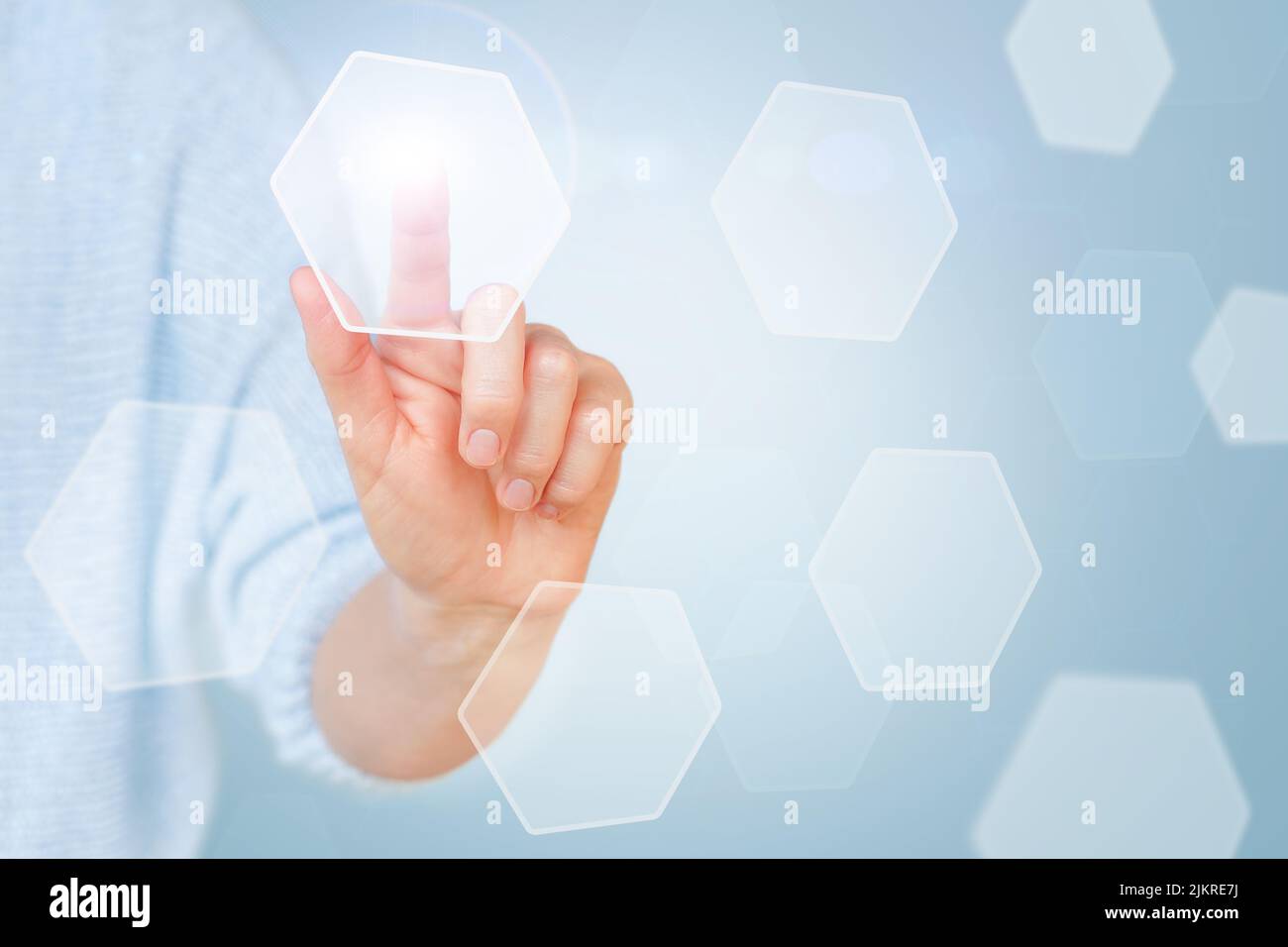 Female hand touching a holographic screen icon. Future technologies and ...
